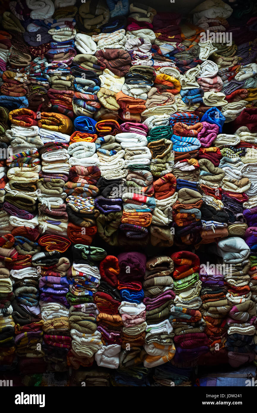Wall of stacked fabric for sale Stock Photo - Alamy