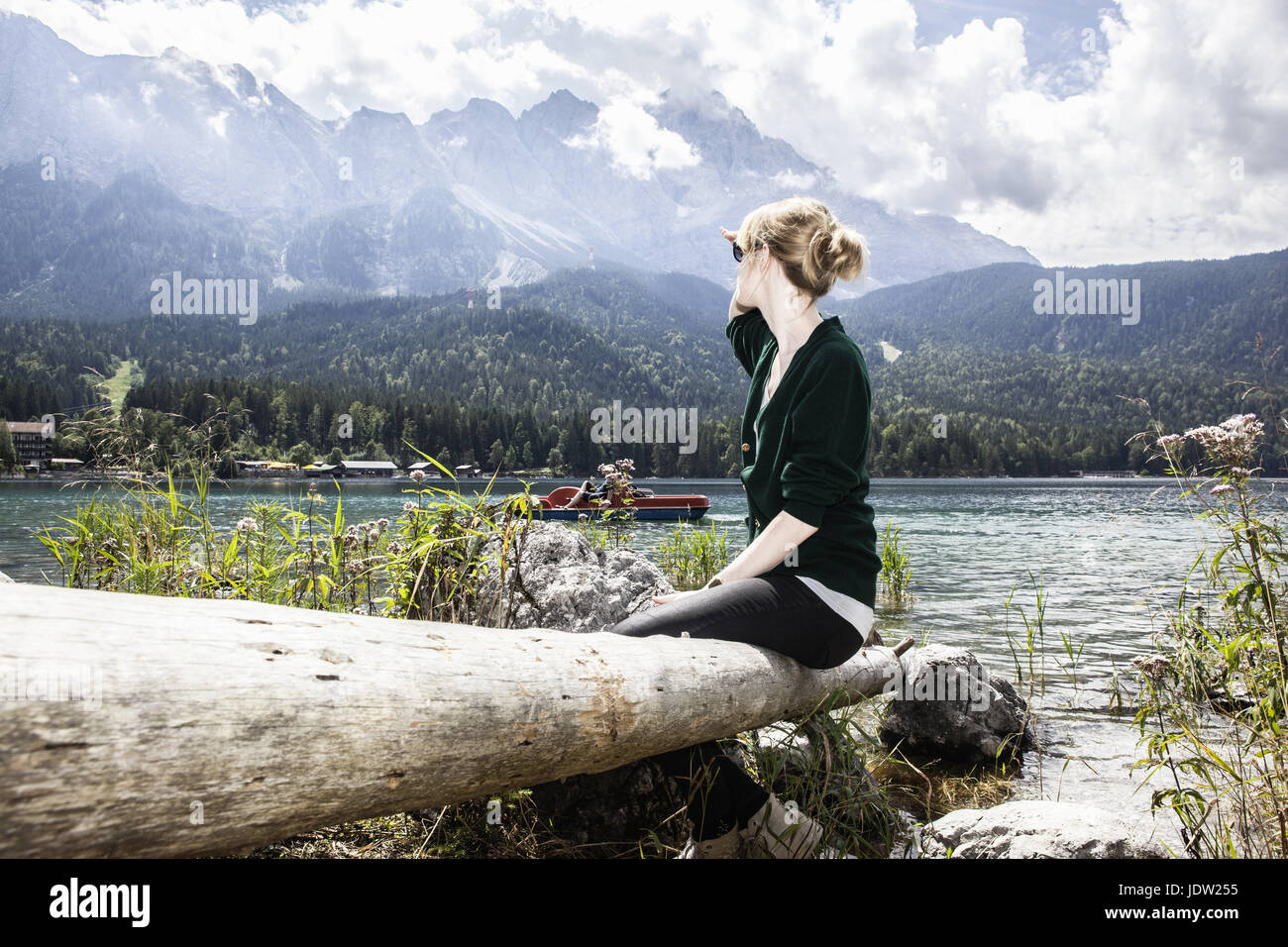 Woman overlooking rural lake Stock Photo - Alamy
