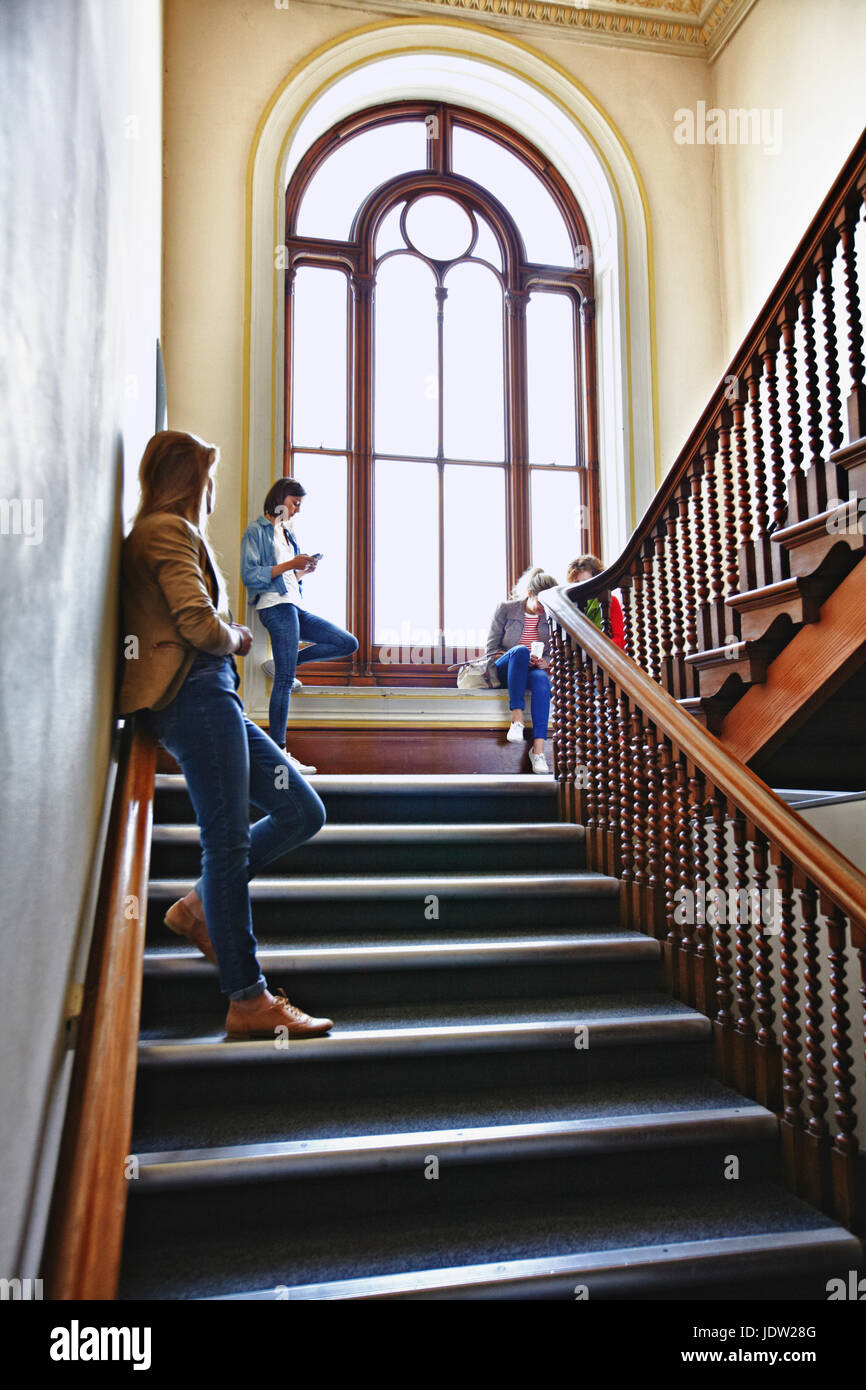 Students hanging out on stairs Stock Photo - Alamy