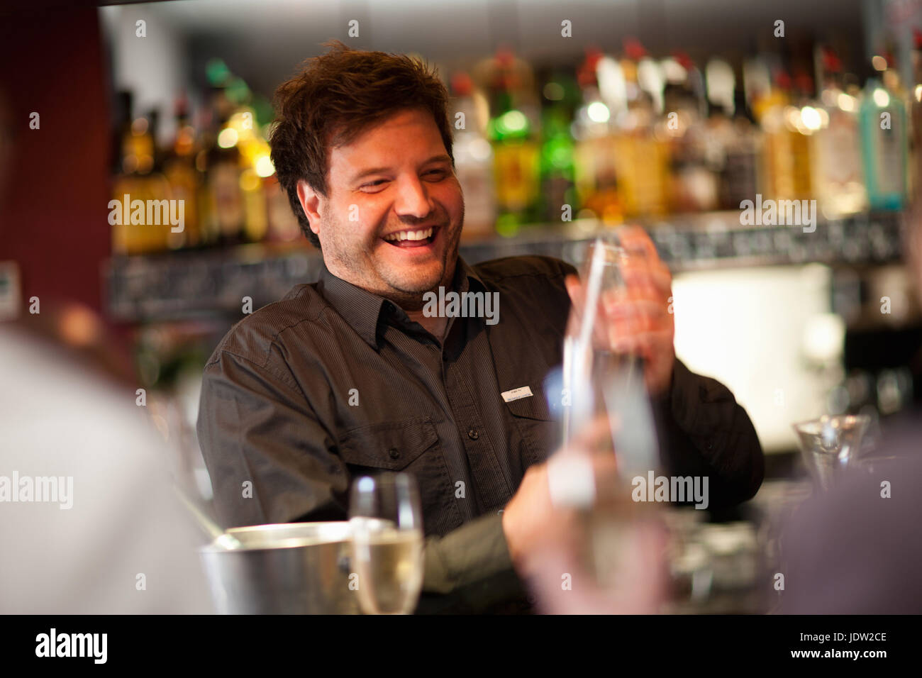 Bartender mixing drinks at bar Stock Photo - Alamy