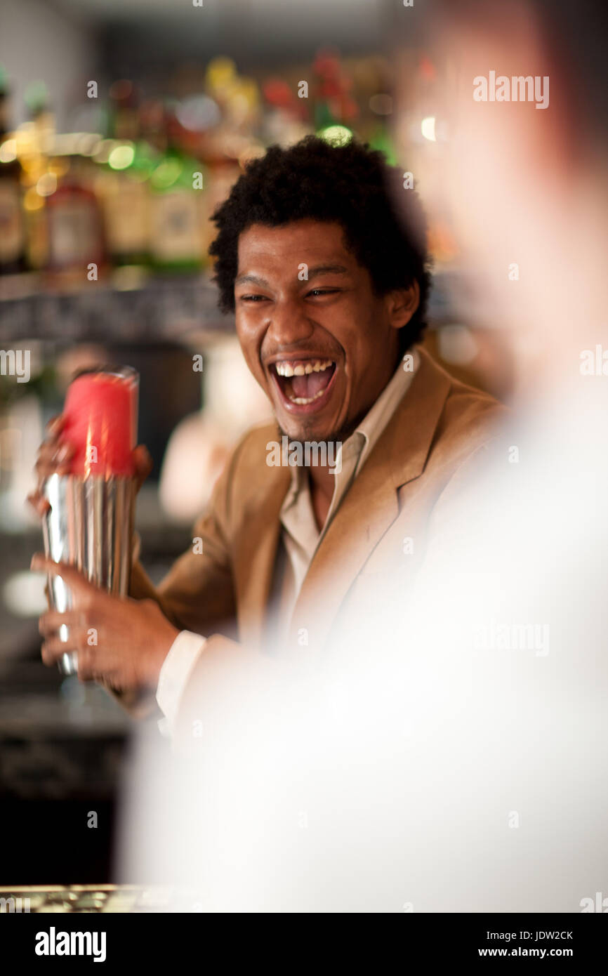 Bartender mixing drinks at bar Stock Photo - Alamy