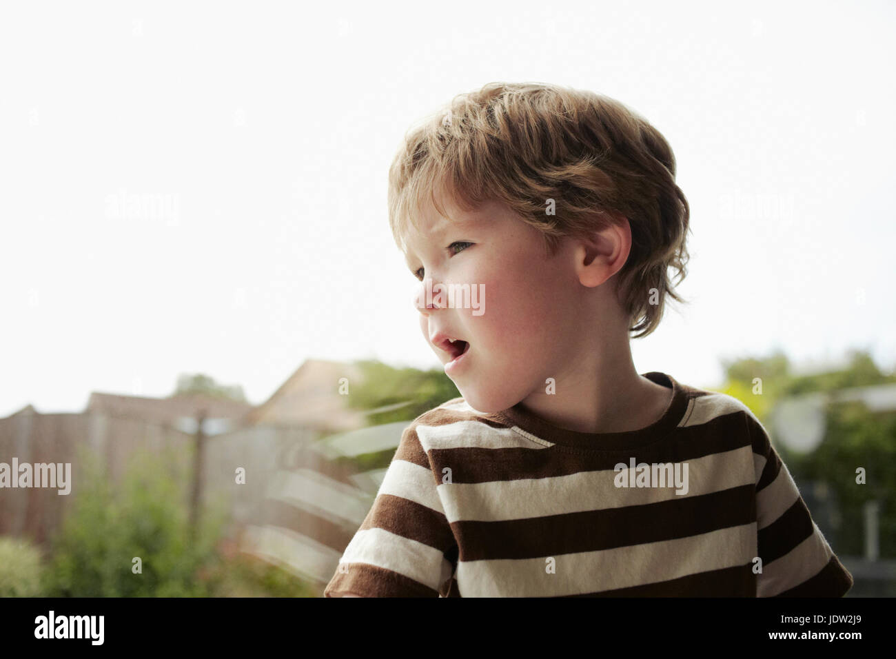 Boy sitting at window Stock Photo - Alamy
