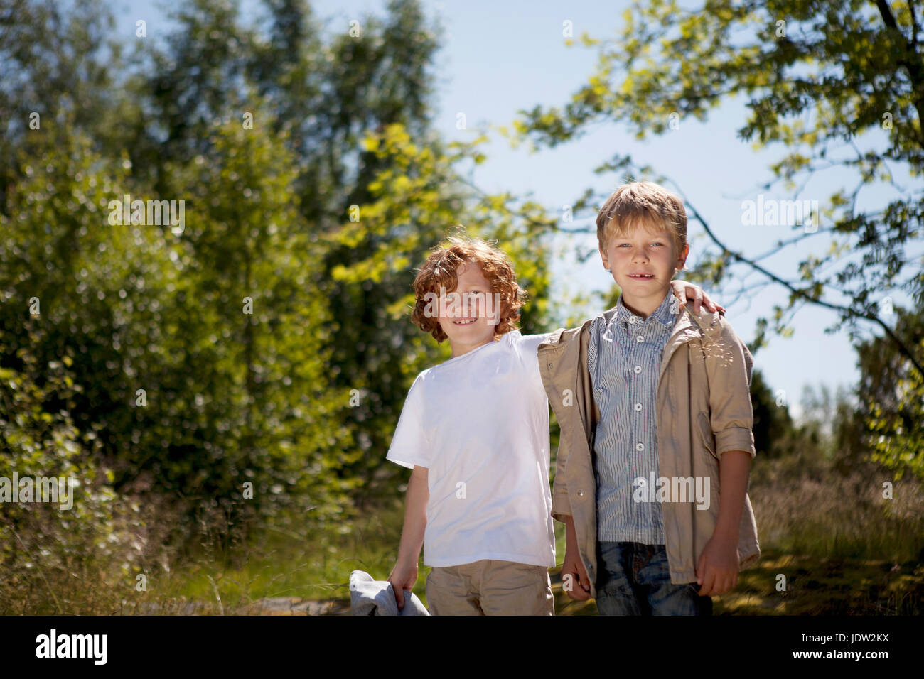Smiling children hugging outdoors Stock Photo - Alamy