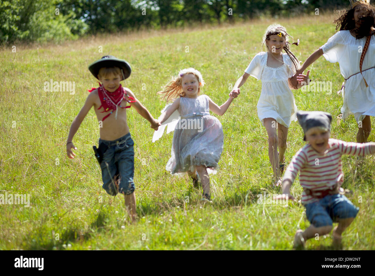 Children running holding hands hi-res stock photography and images - Alamy