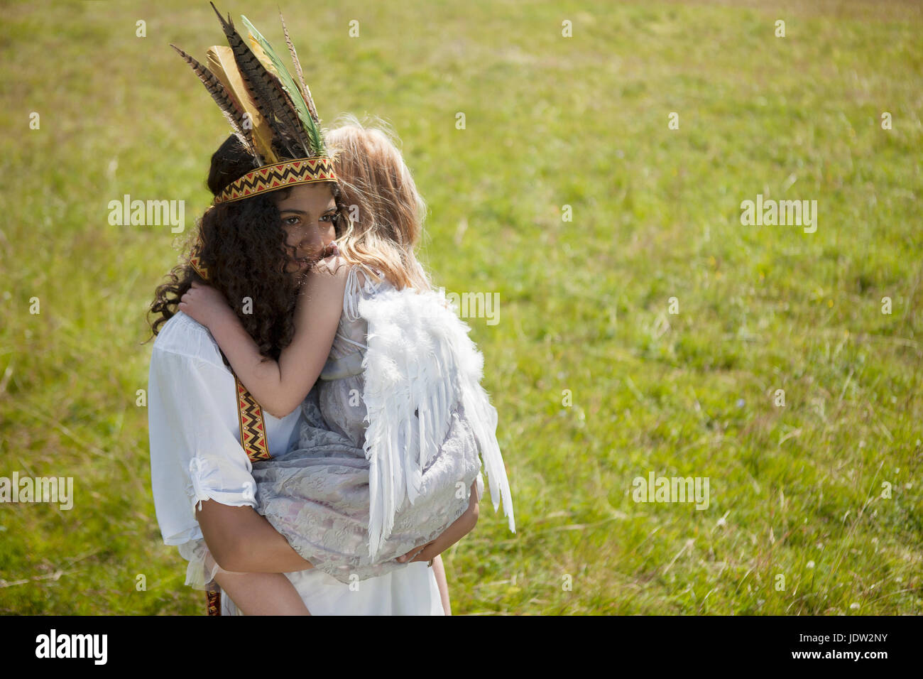 Girls in costume hugging outdoors Stock Photo - Alamy