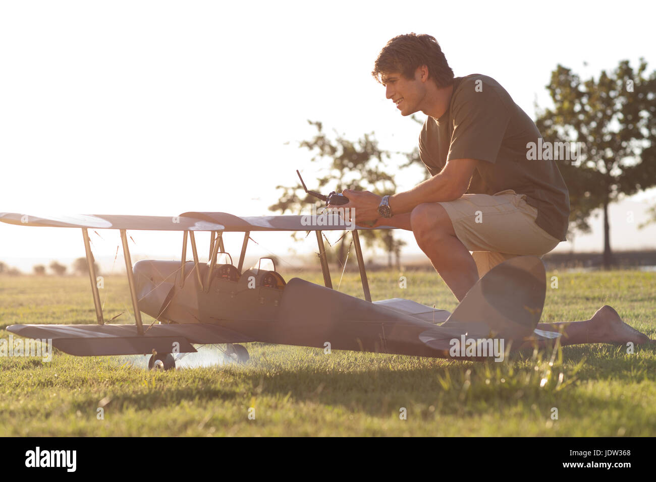 Man flying toy airplane in park Stock Photo - Alamy