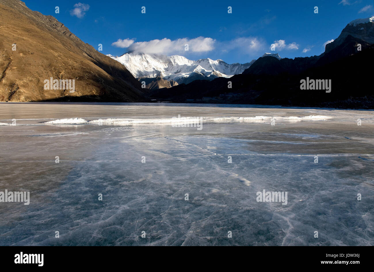 Mountains overlooking frozen valley Stock Photo - Alamy