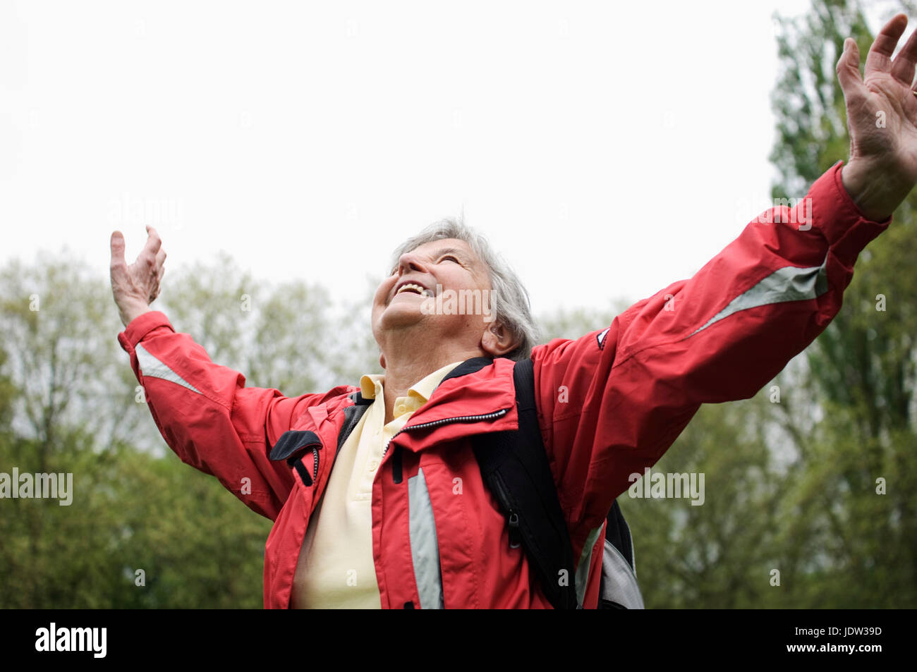 Older woman cheering in park Stock Photo - Alamy