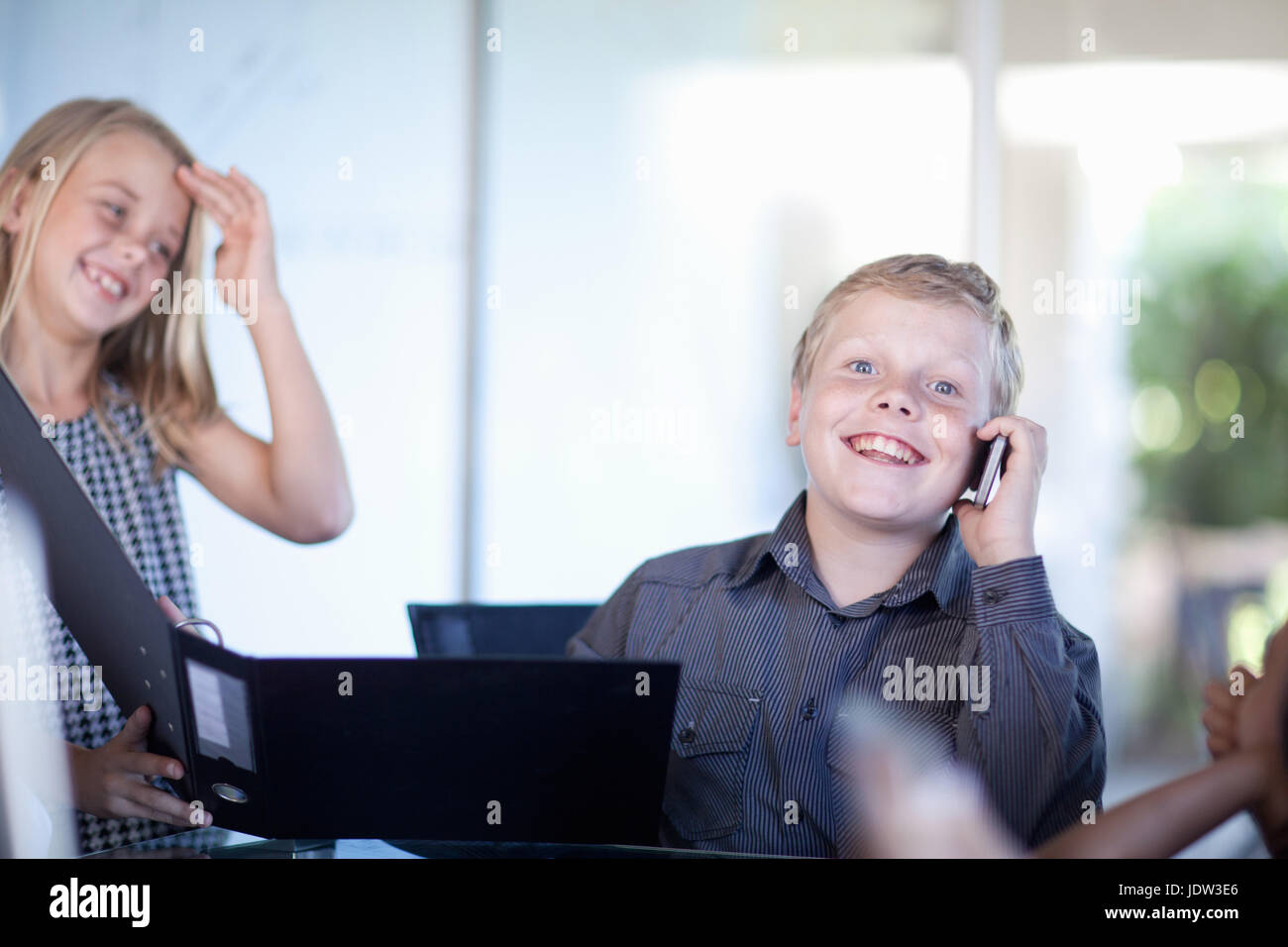 Children playing business people at desk Stock Photo - Alamy