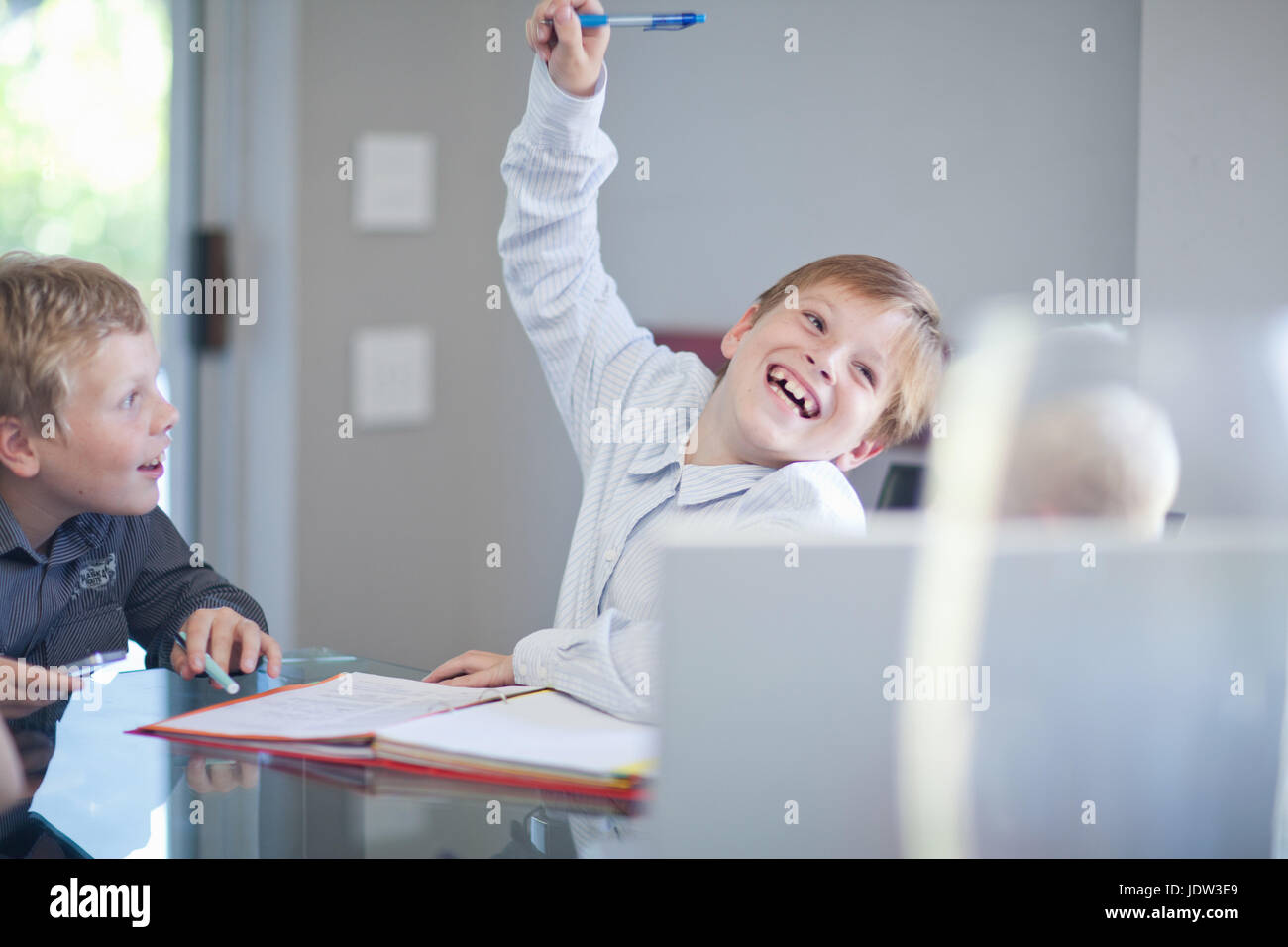 Boys playing businessmen at desk Stock Photo - Alamy