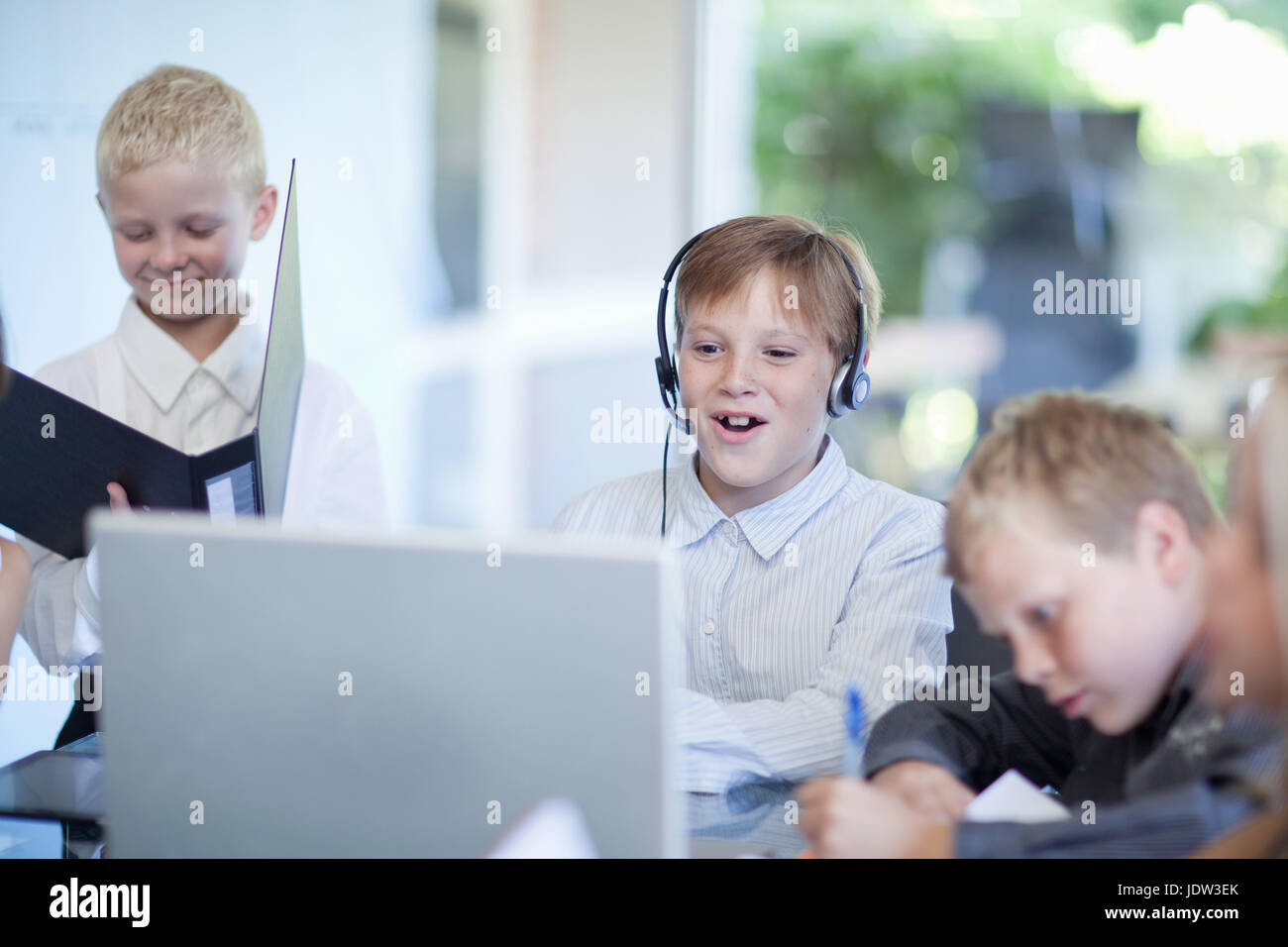 Boys playing businessmen at desk Stock Photo - Alamy