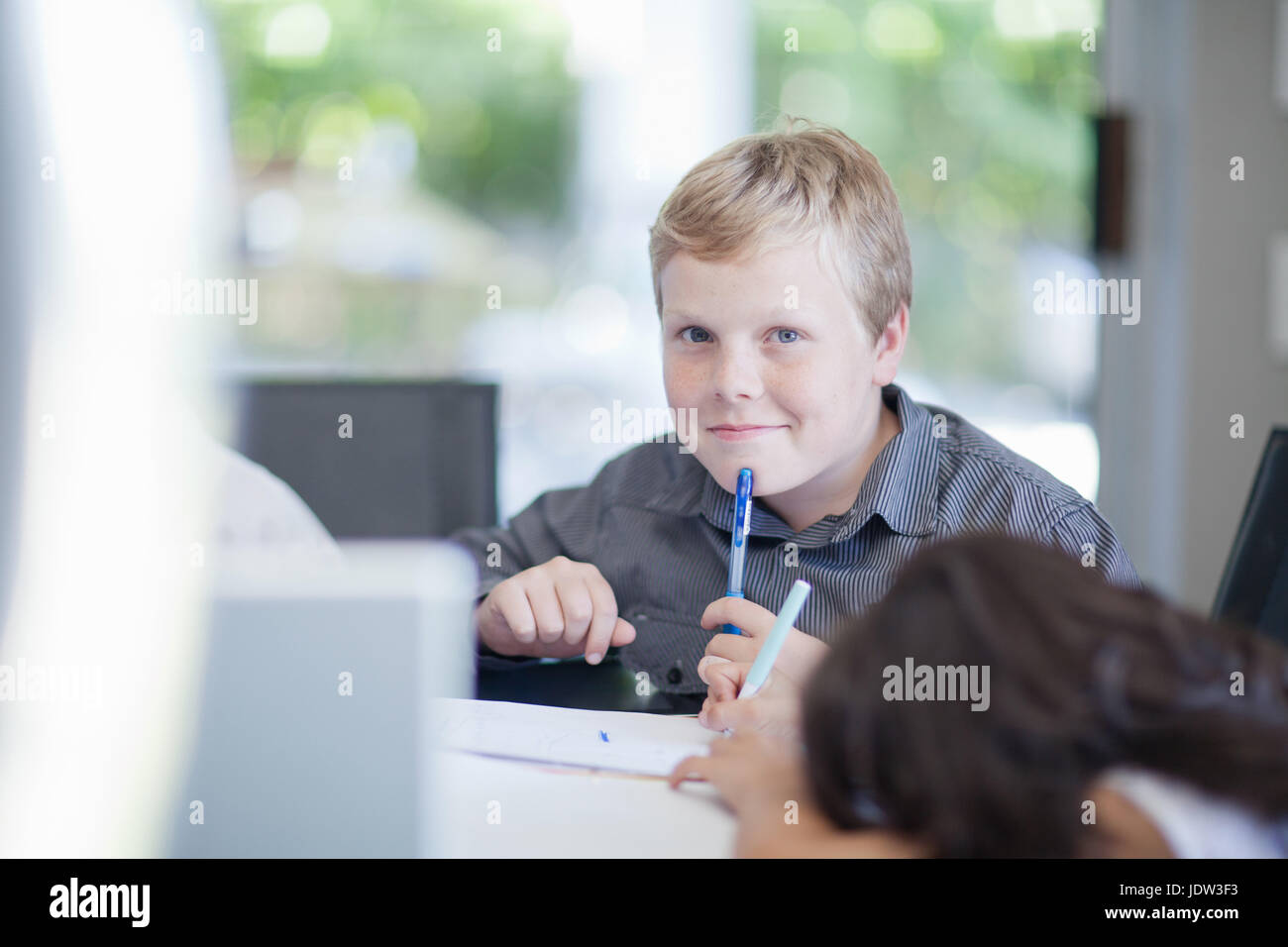 Boy playing businessman at desk Stock Photo - Alamy
