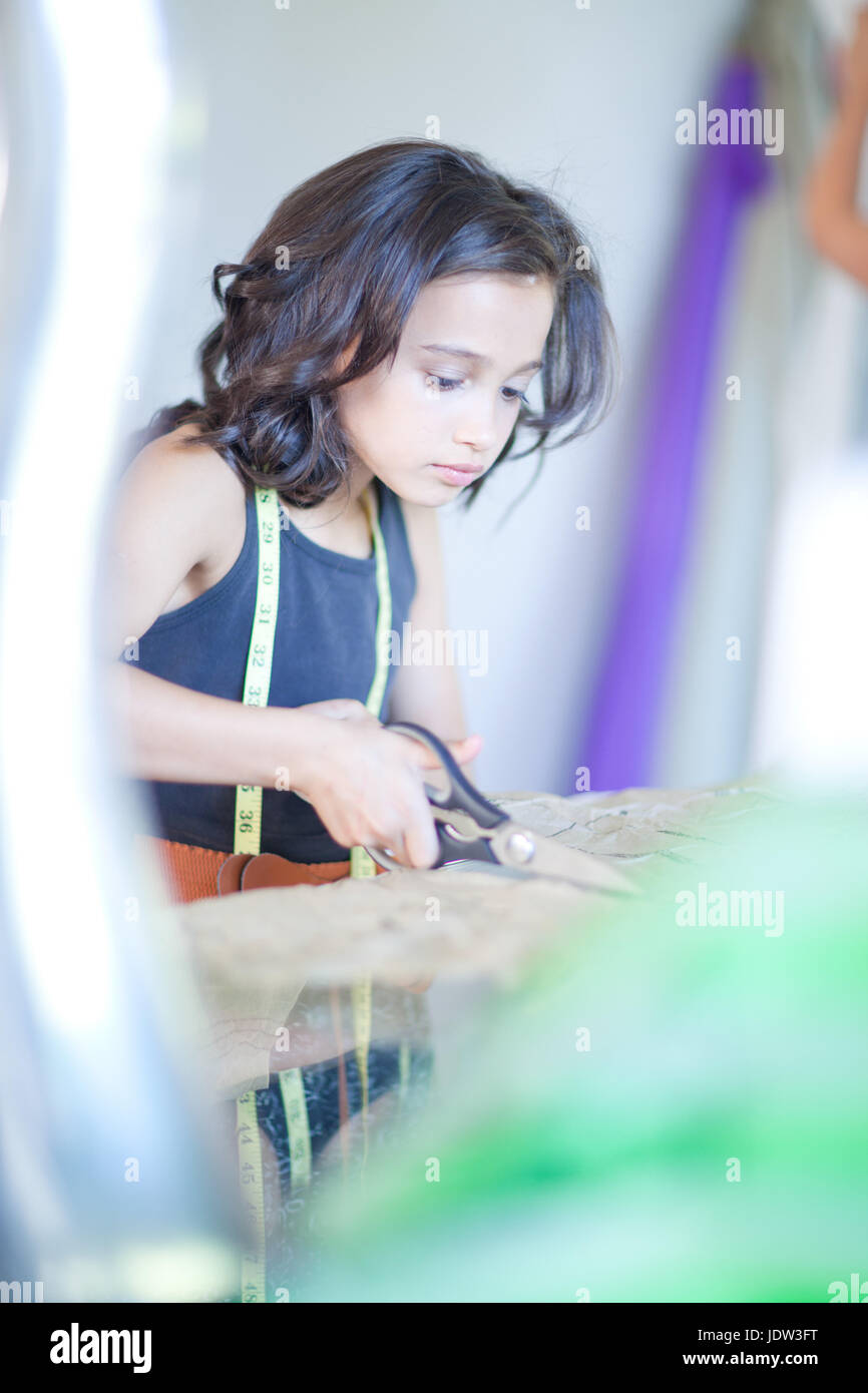 Girl cutting fabric for dressmaking Stock Photo - Alamy