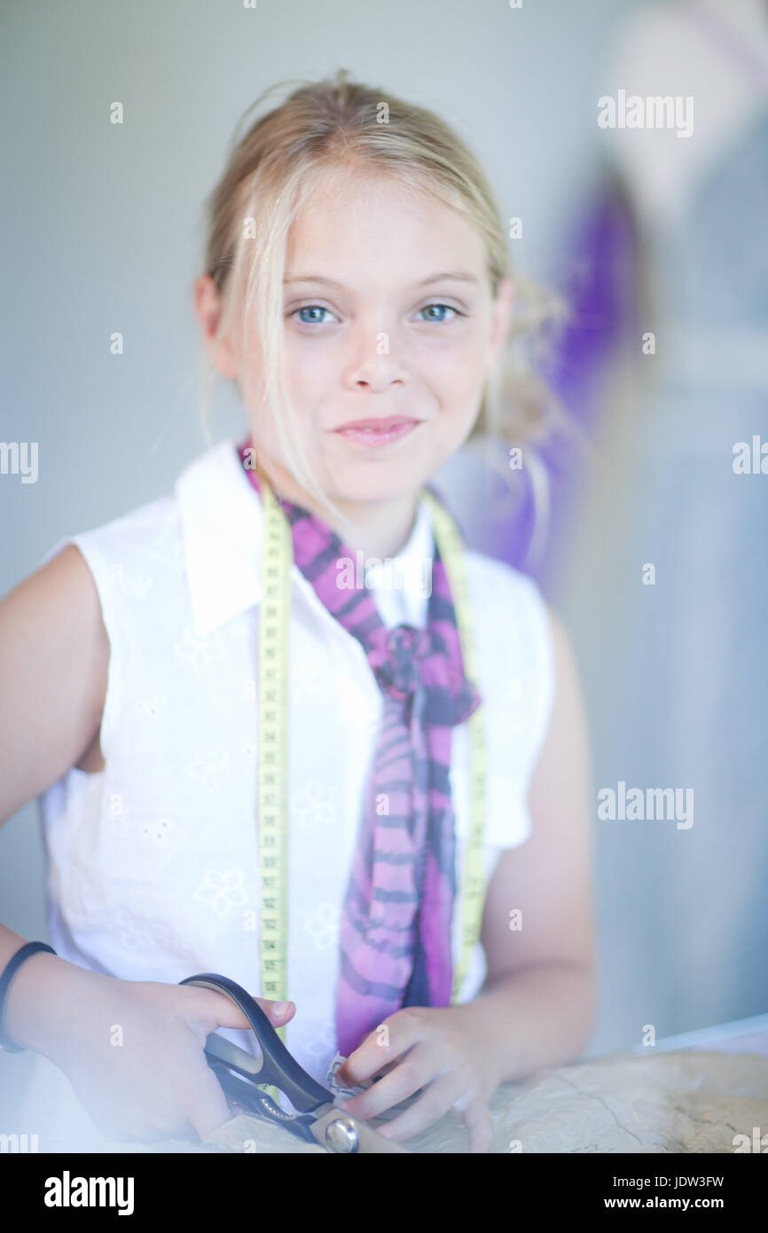 Girl using pair of scissors Stock Photo - Alamy