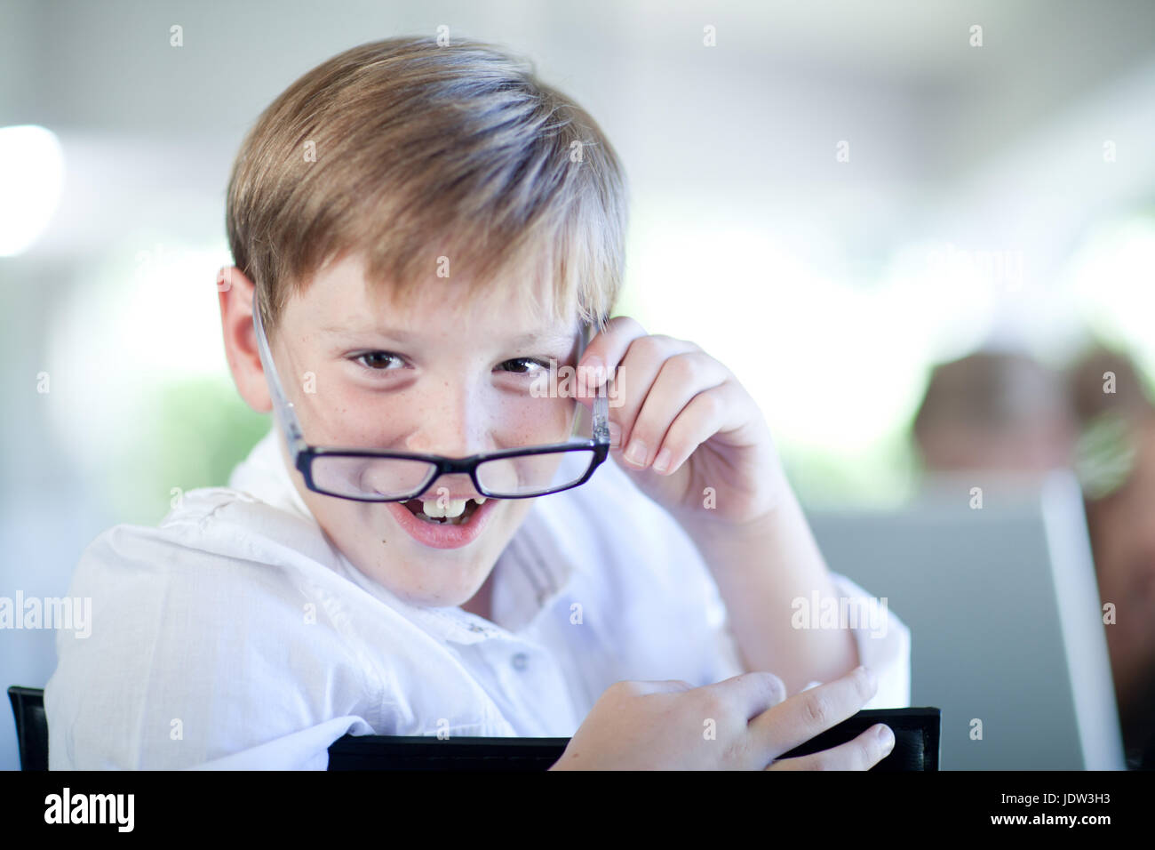 Boy playing businessman at desk Stock Photo - Alamy
