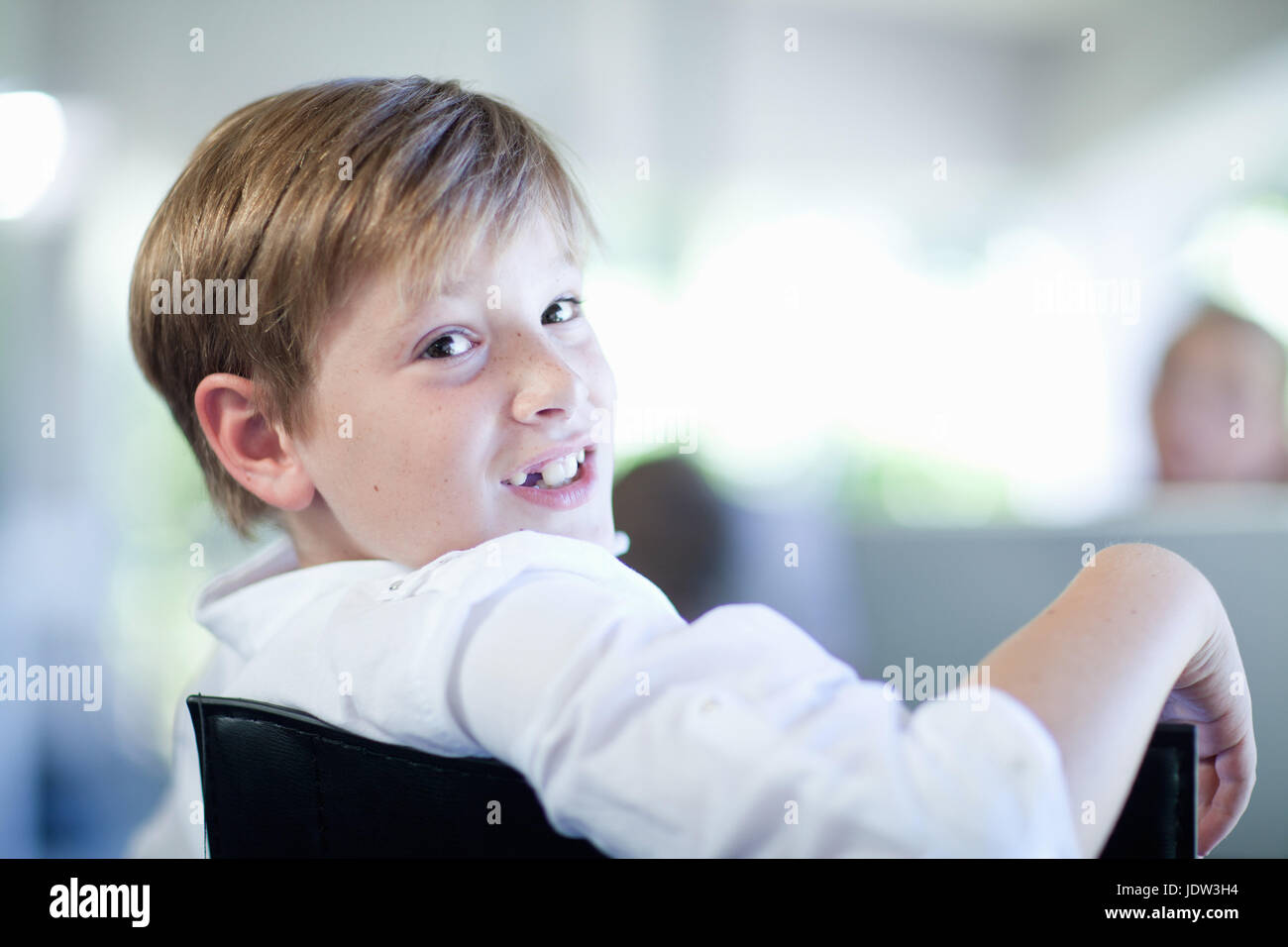 Boy playing businessman at desk Stock Photo - Alamy