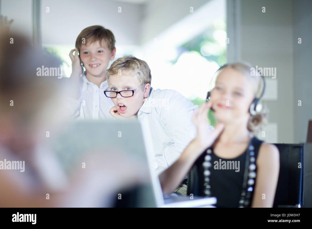 Children playing business people at desk Stock Photo - Alamy