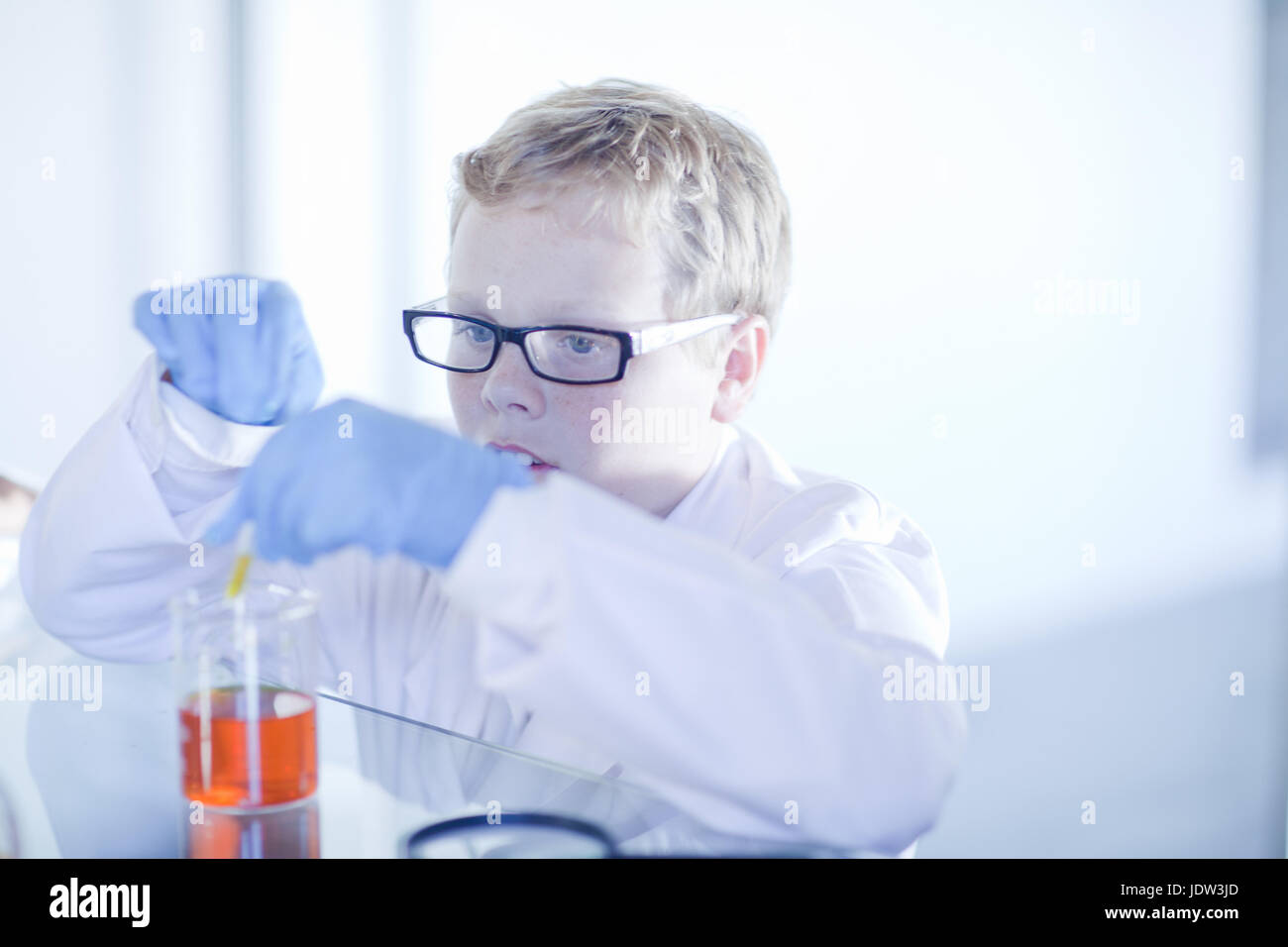 Boy playing scientist in lab Stock Photo - Alamy