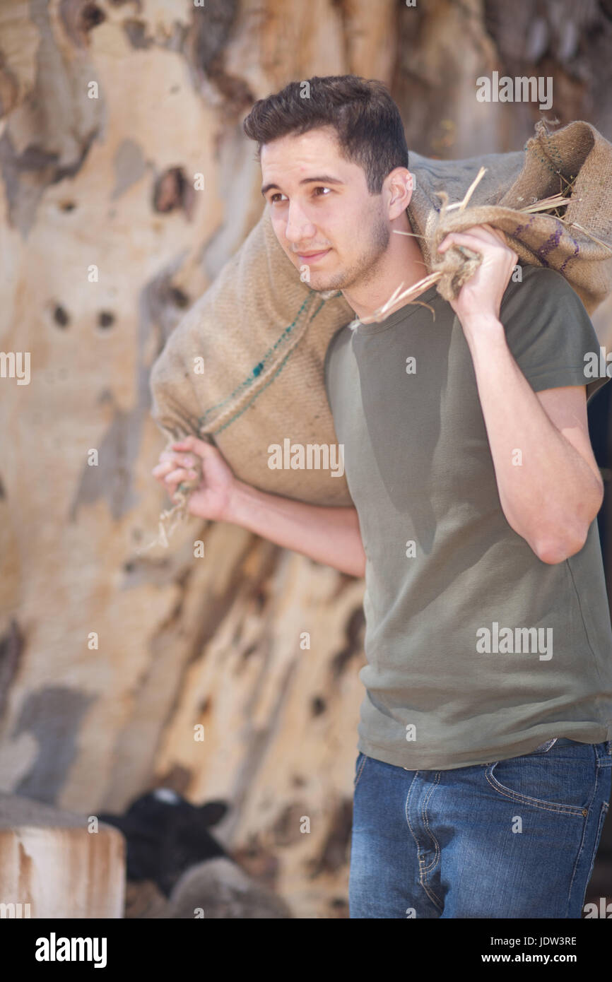 Man carrying heavy bag hi-res stock photography and images - Alamy