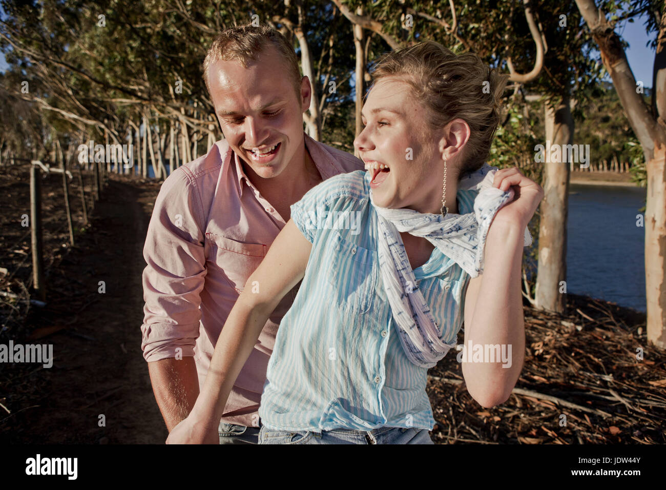 Young couple laughing in forest Stock Photo - Alamy