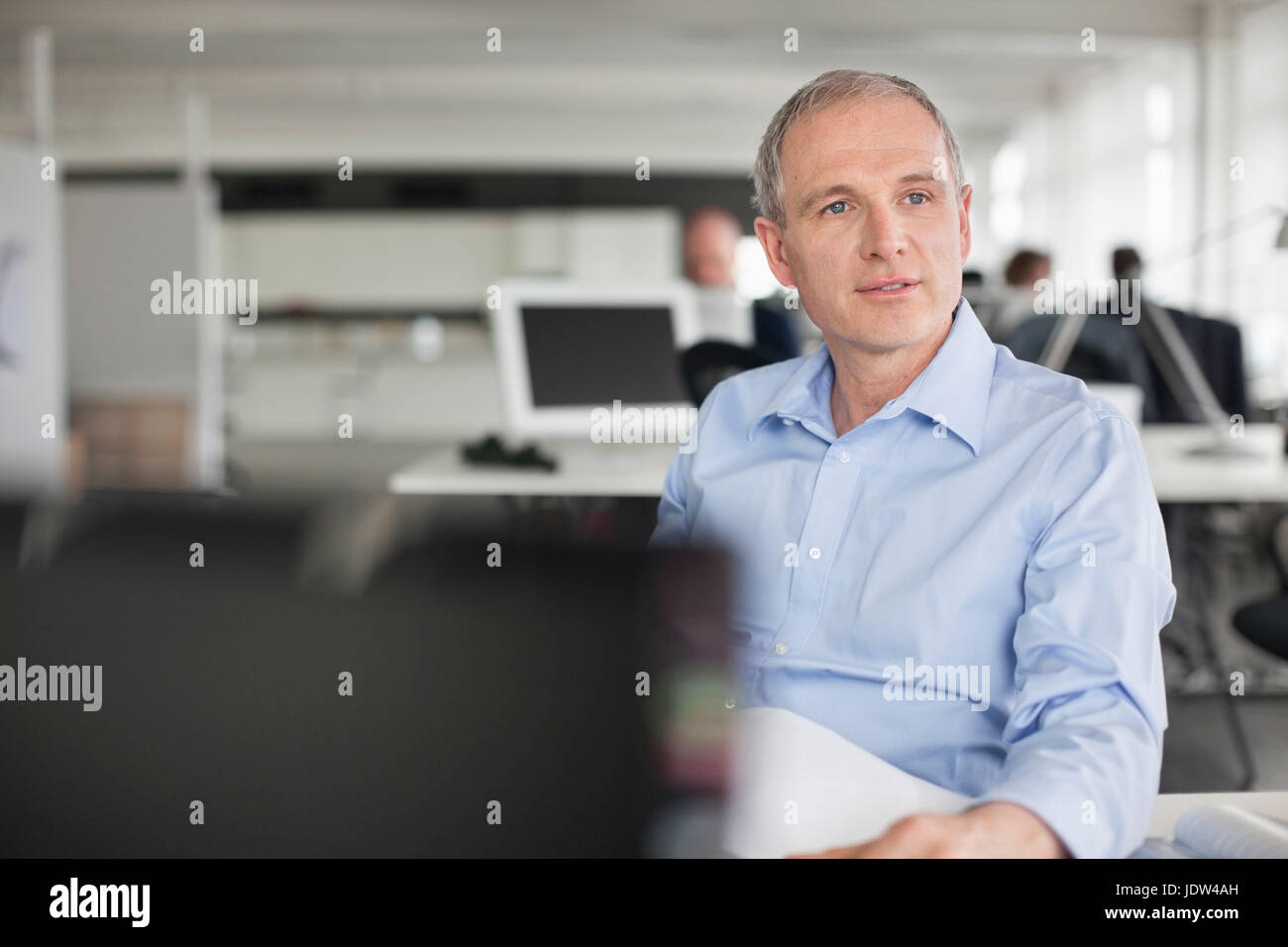 Male in suit sitting desk hi-res stock photography and images - Alamy