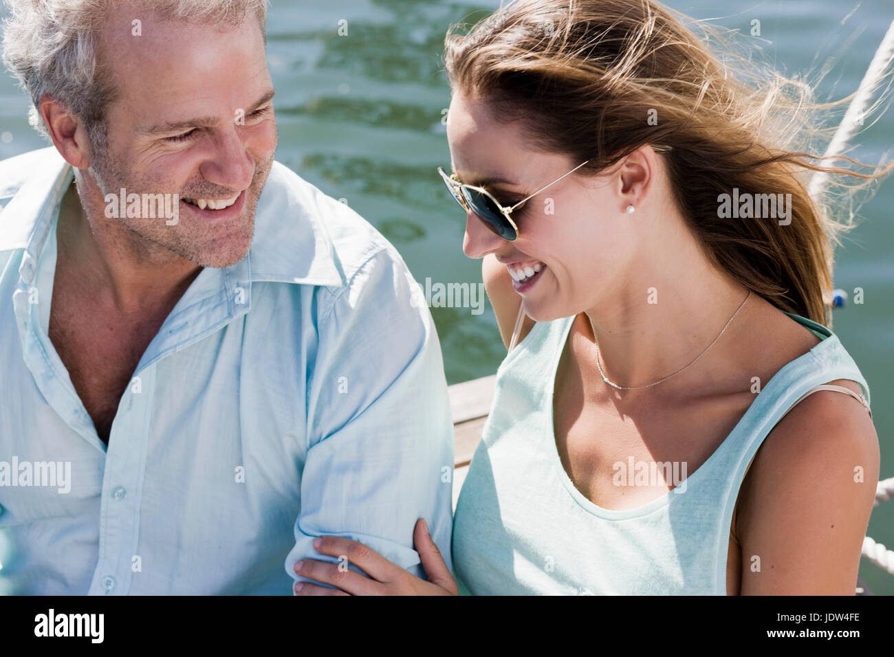 Couple on yacht, woman touching man's arm Stock Photo - Alamy