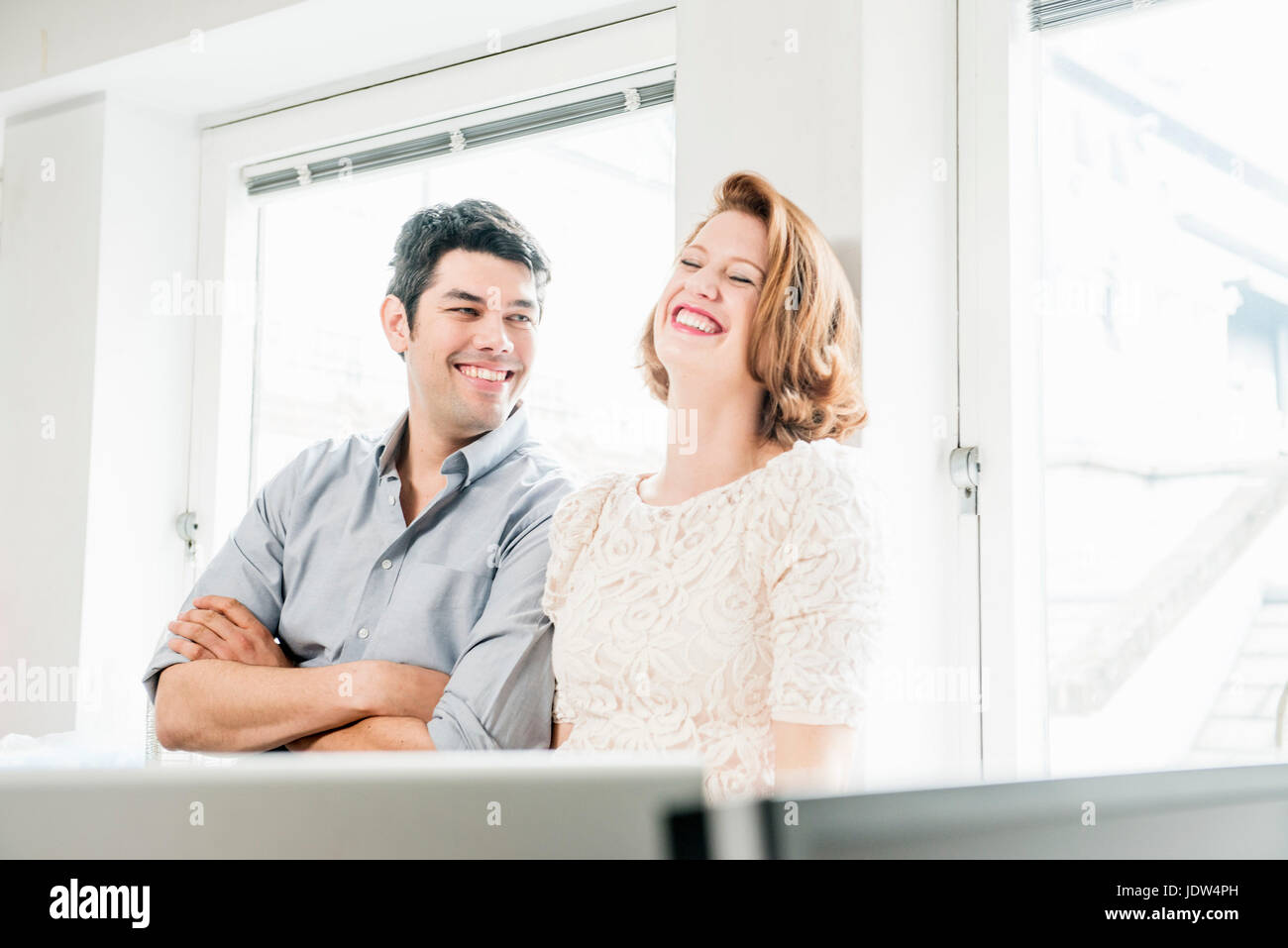 Office colleagues laughing Stock Photo - Alamy