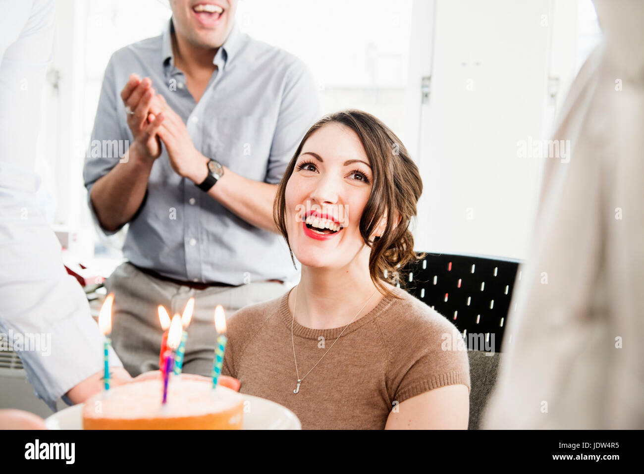 Female office worker receiving birthday cake Stock Photo - Alamy