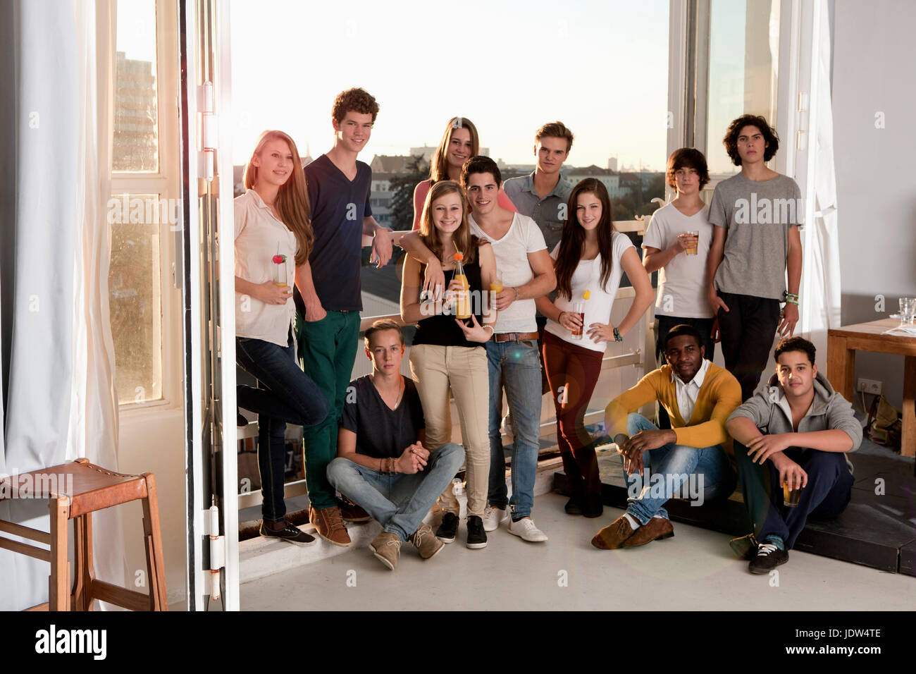 Group of friends at house party on balcony Stock Photo - Alamy