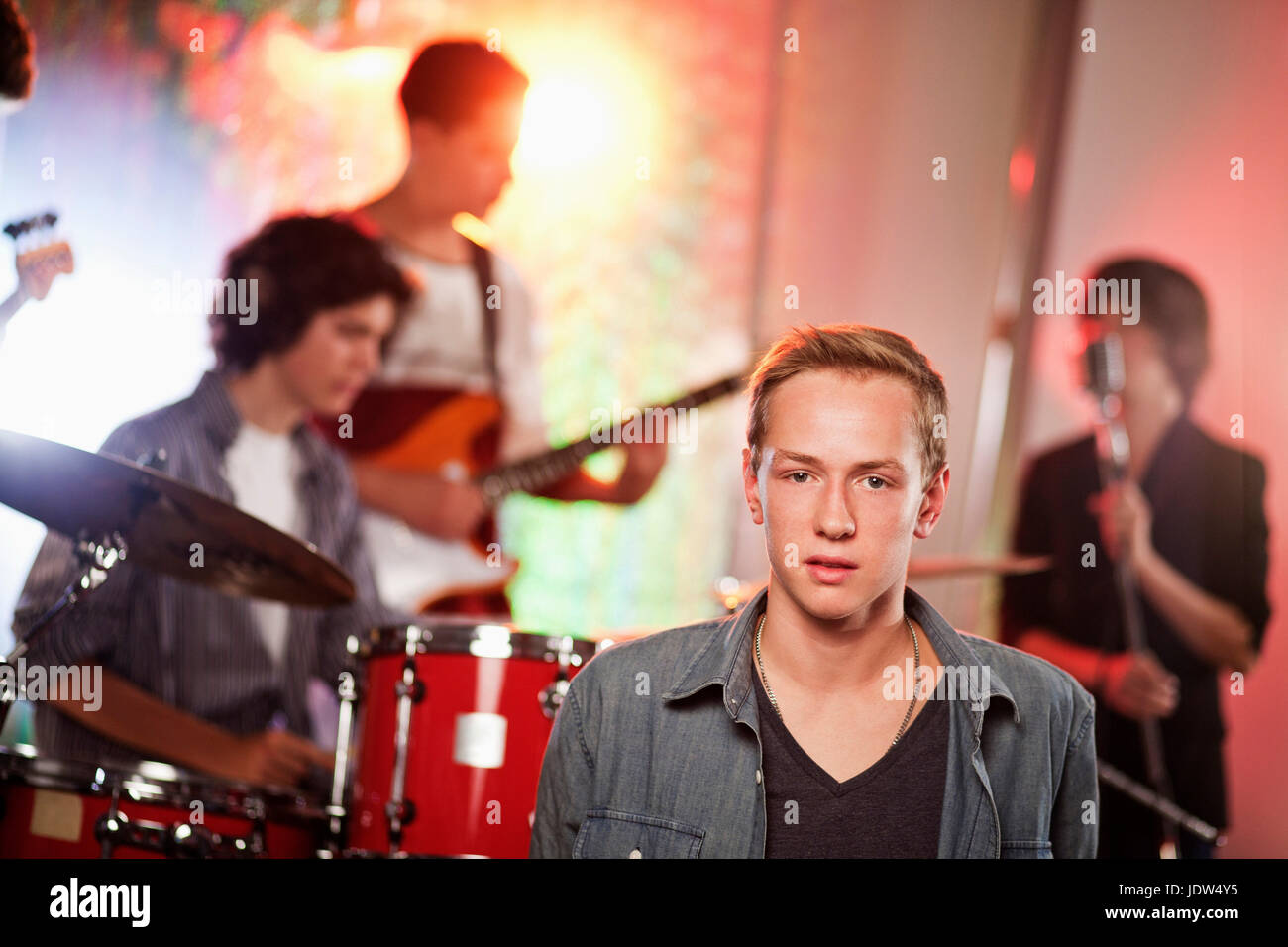 Teenage boy with band in background Stock Photo - Alamy