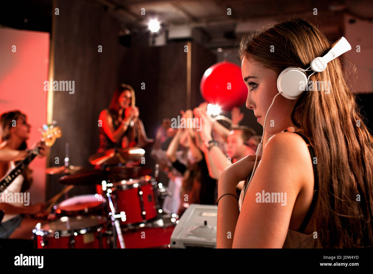 Teenagers at concert, girl wearing headphones Stock Photo - Alamy