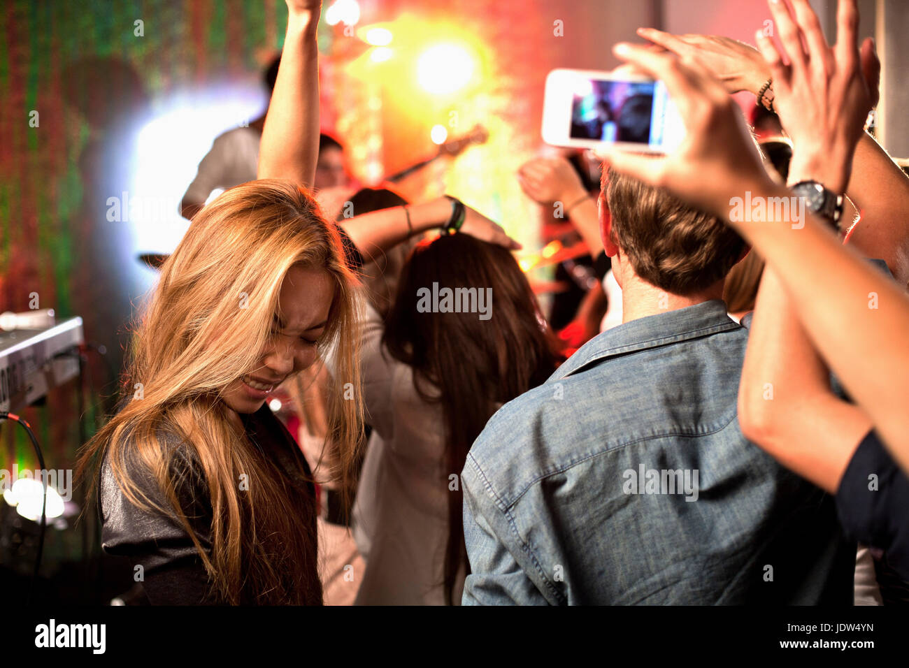 Teenagers photographing band on camera phones at concert Stock Photo ...