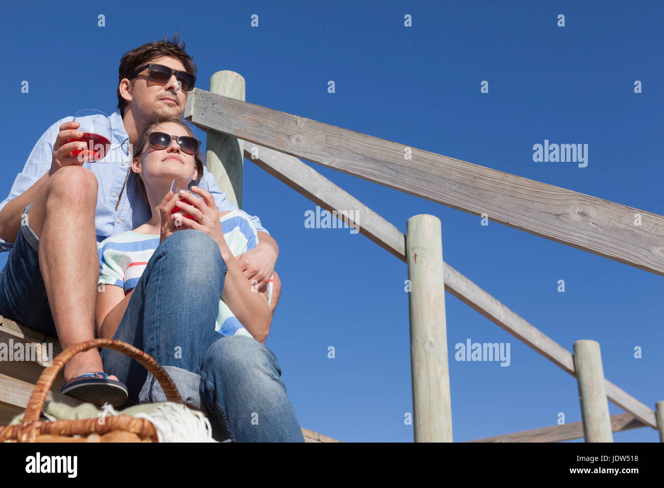 Woman sitting wooden boardwalk hi-res stock photography and images - Alamy
