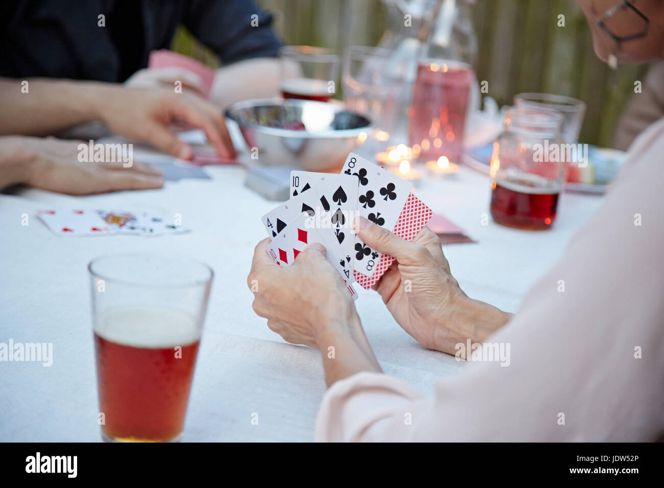 Friends playing card game at garden party Stock Photo - Alamy