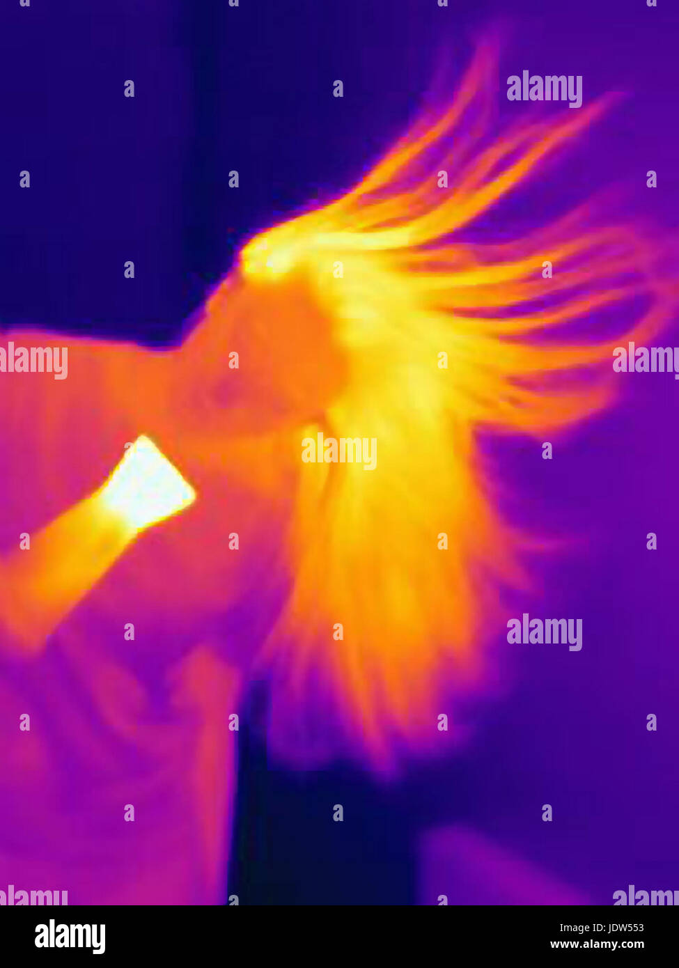 Thermal image of young woman drying her hair Stock Photo - Alamy