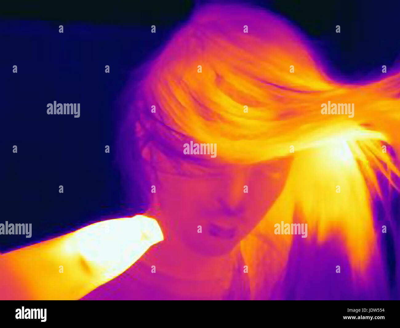 Thermal image of young woman drying her hair Stock Photo - Alamy