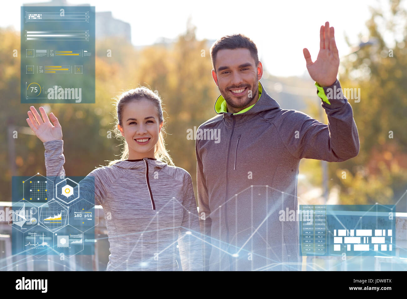 smiling couple waving hand outdoors Stock Photo - Alamy