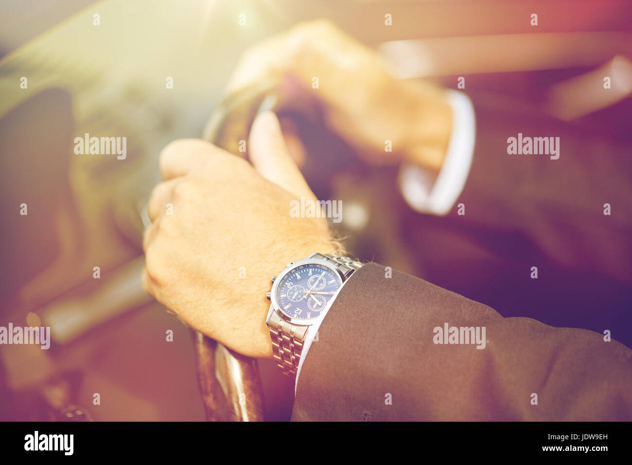 senior businessman hands driving car Stock Photo - Alamy