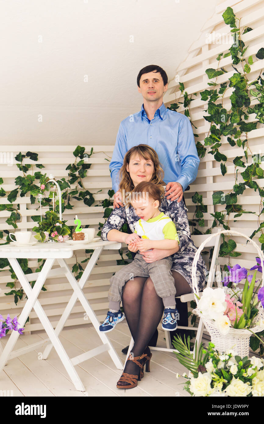 kid with parents celebrating birthday. Happy family celebrating birth ...