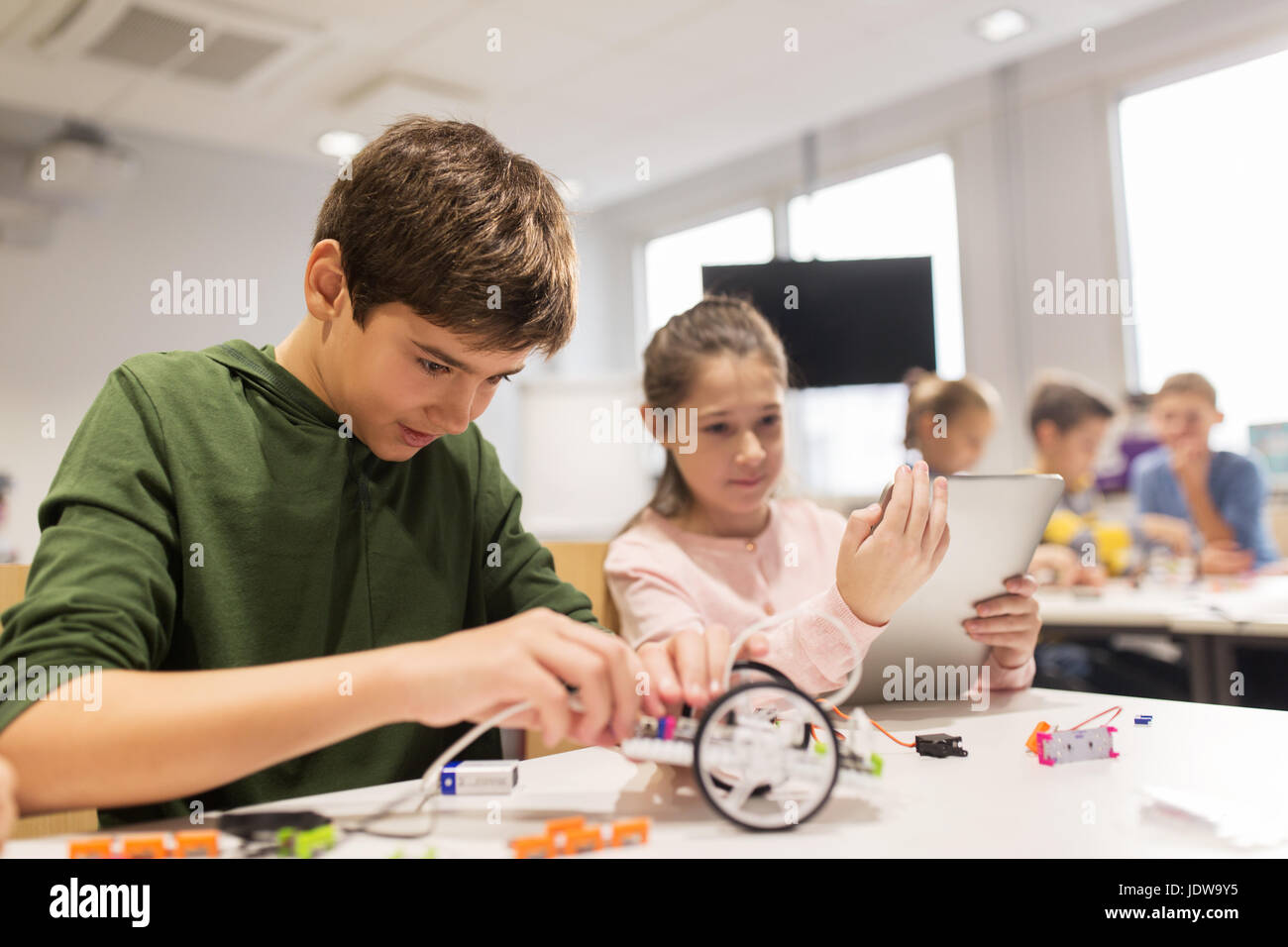 kids with tablet pc programming at robotics school Stock Photo - Alamy