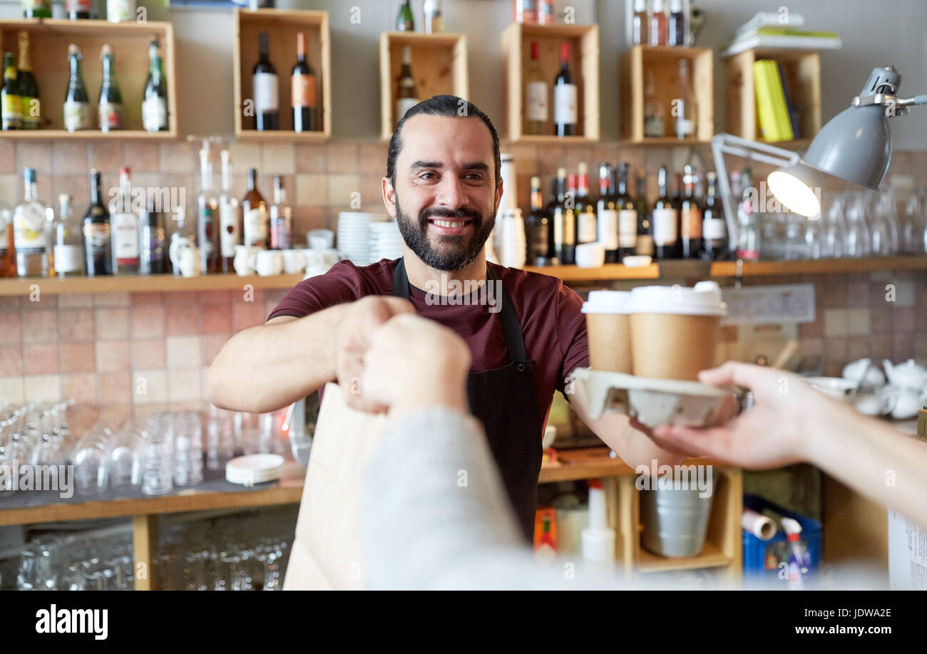 man or waiter serving customer at coffee shop Stock Photo - Alamy