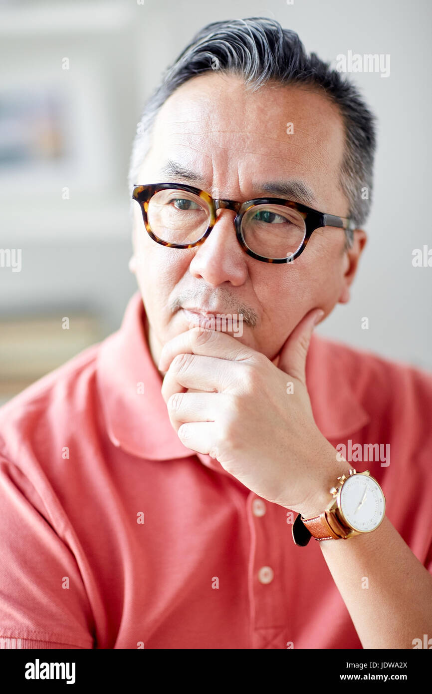 asian man thinking at home Stock Photo - Alamy