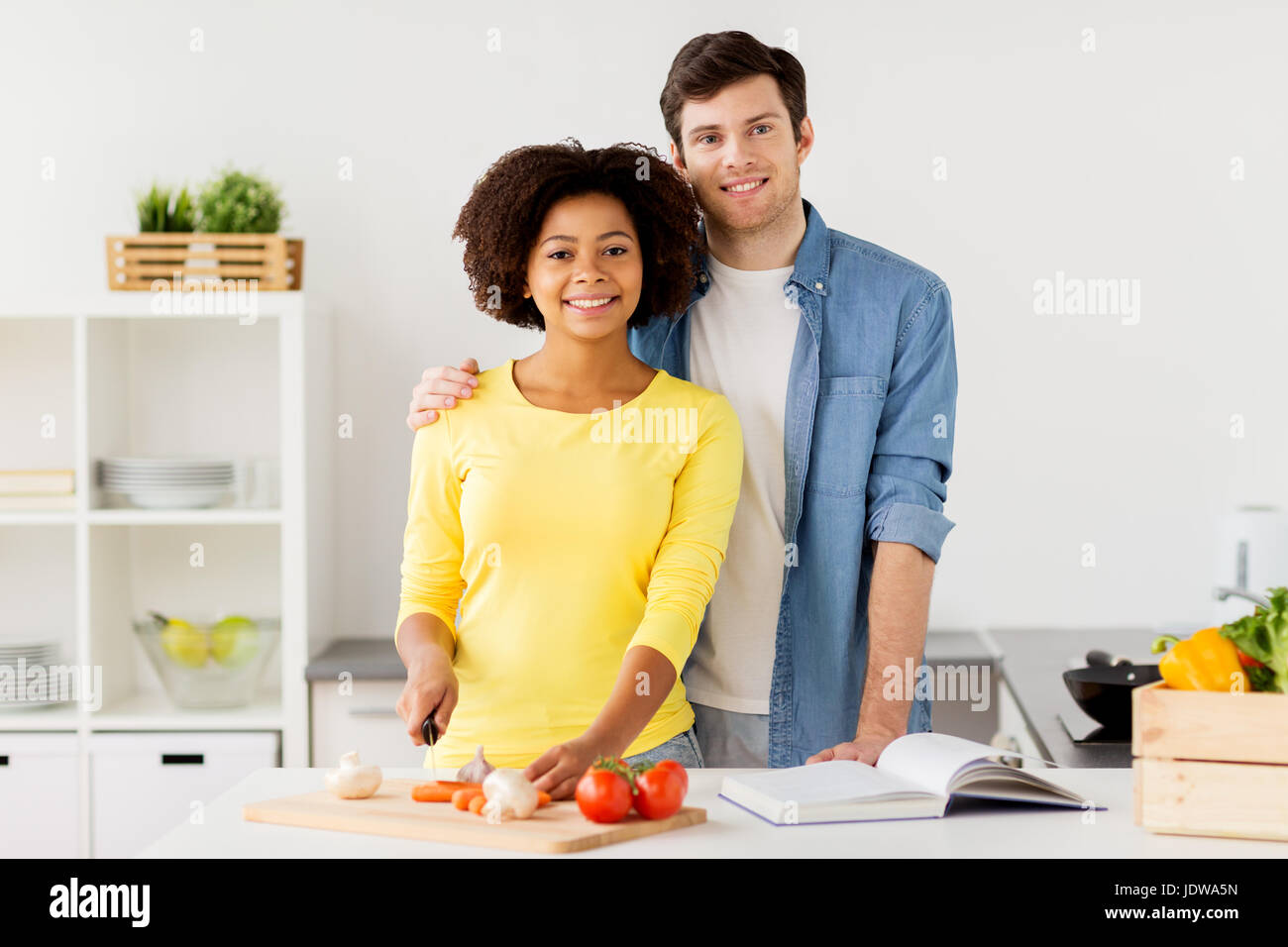 happy couple cooking food at home kitchen Stock Photo - Alamy