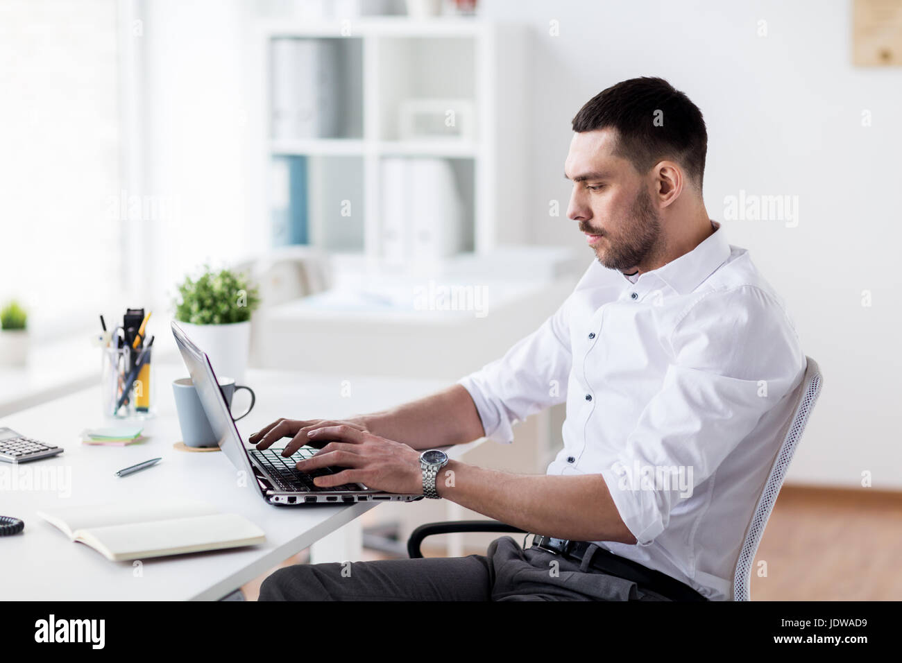 businessman typing on laptop at office Stock Photo - Alamy