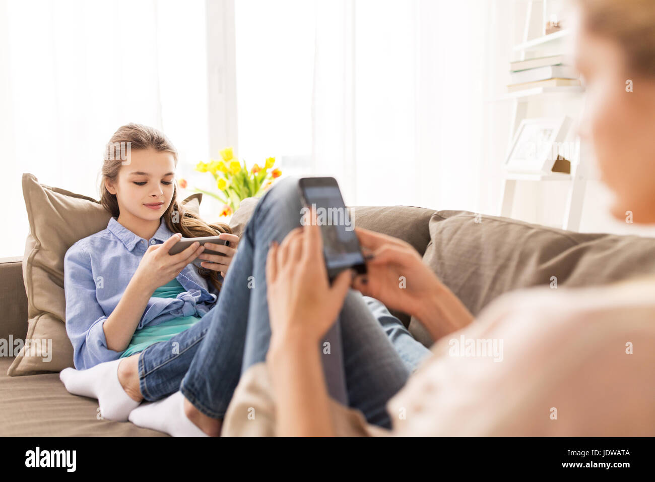 happy family with smartphones at home Stock Photo - Alamy