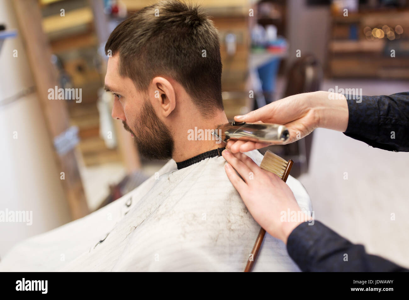 man and barber hands with trimmer cutting hair Stock Photo - Alamy