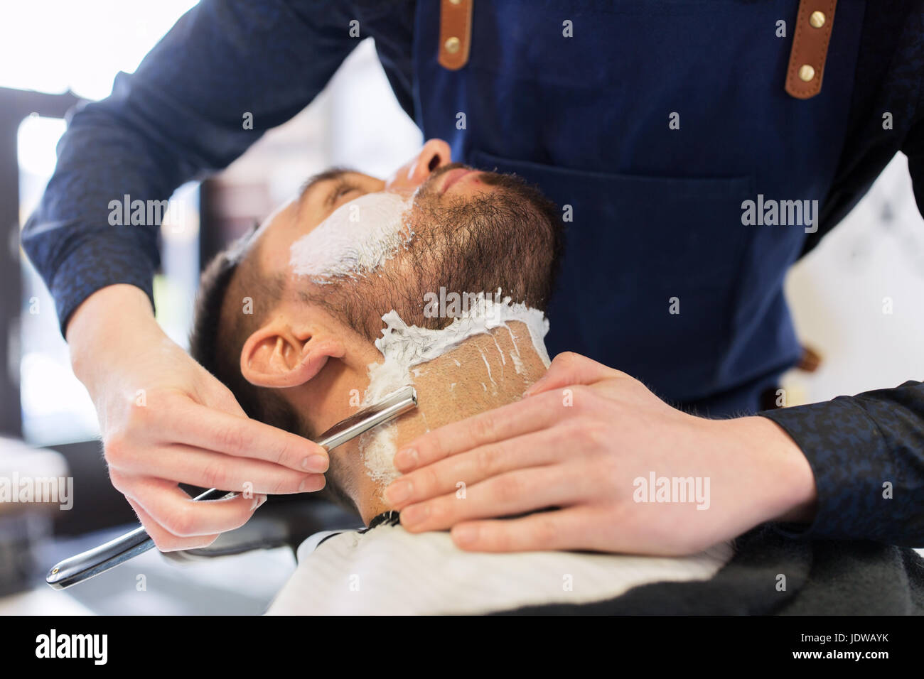 man and barber with straight razor shaving beard Stock Photo - Alamy