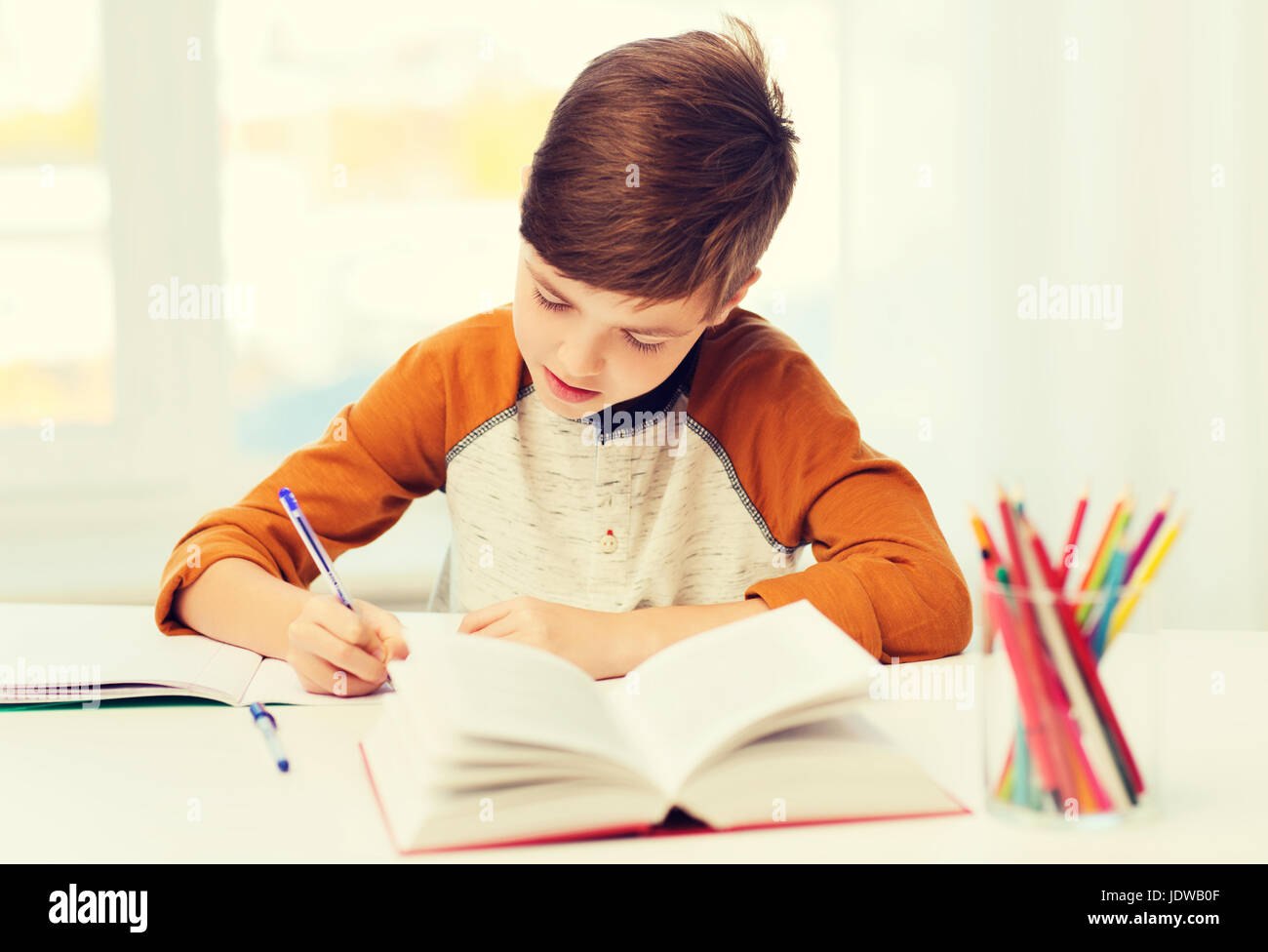 Boy writing book hi-res stock photography and images - Alamy