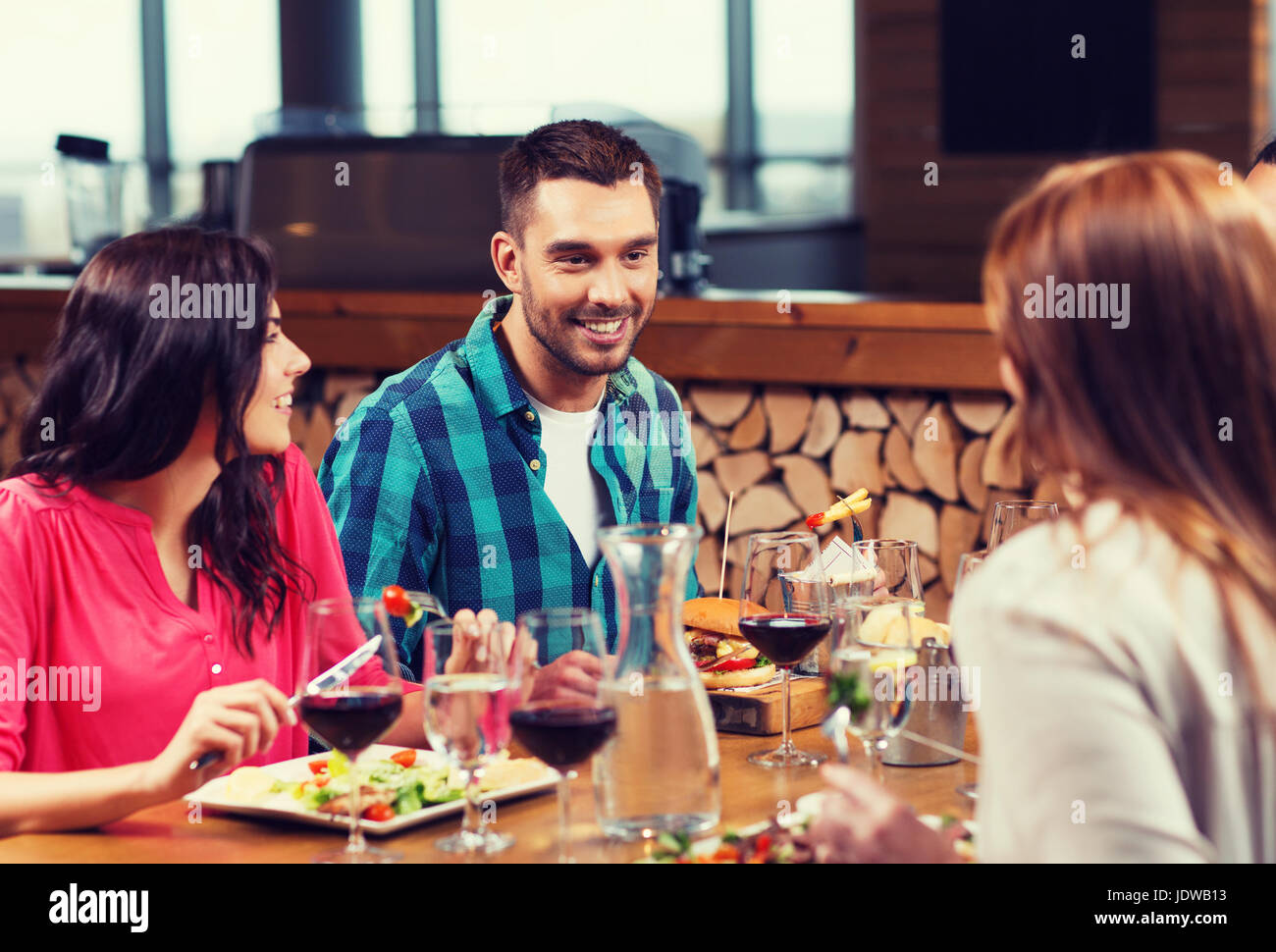 happy friends having dinner at restaurant Stock Photo - Alamy