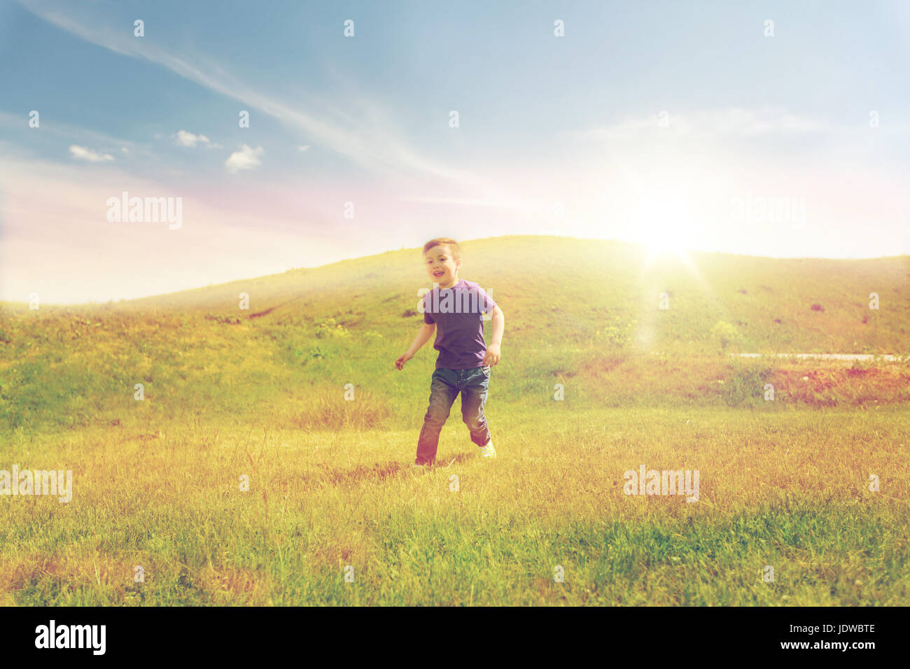 happy little boy running on green field outdoors Stock Photo - Alamy